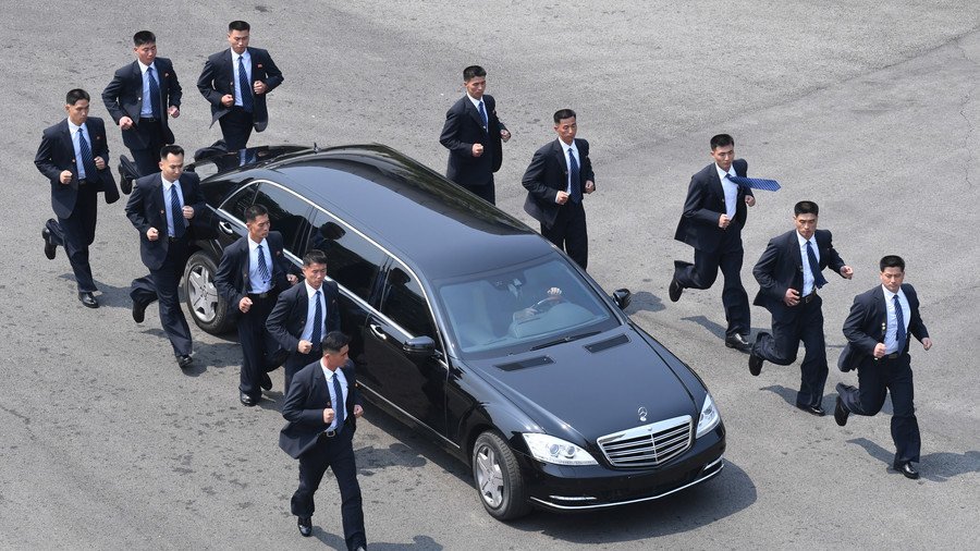 Kim Jong-un's ‘Men in Black’ jog outside his car, as the leader heads ...