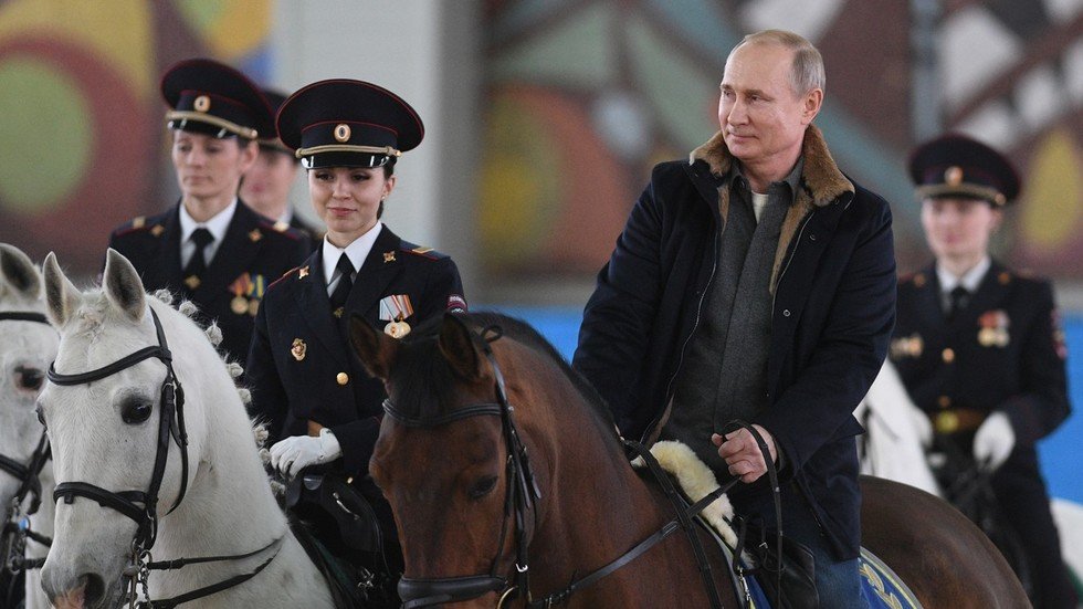 Putin rides horse (this time fully clothed) alongside mounted female ...