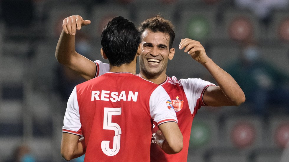 Iranian footballer hit with 6-month ban for 'eye-slant' celebration in ...