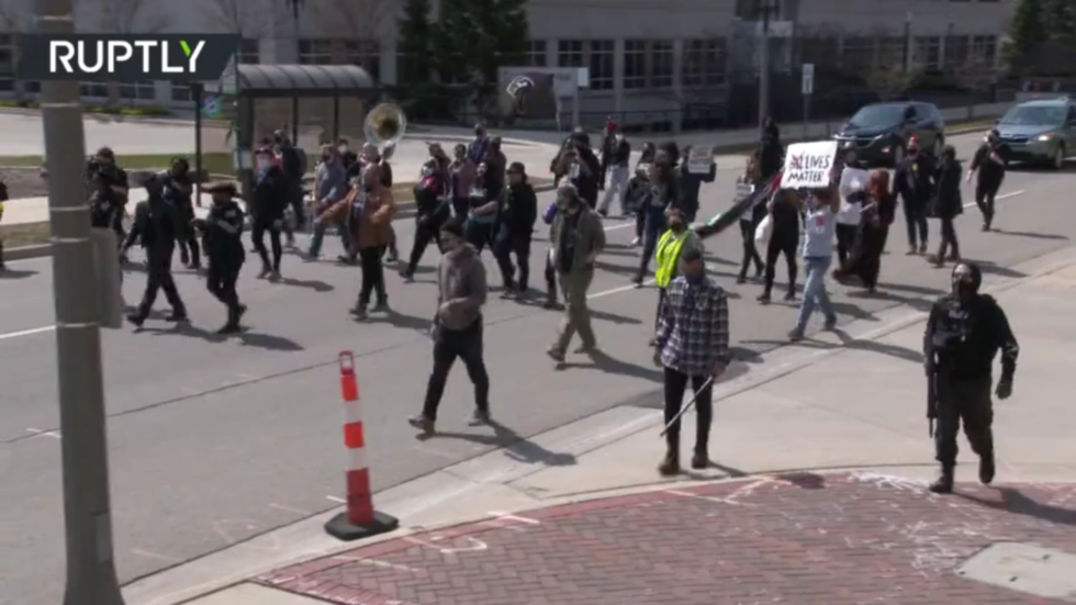 Armed activists join march in protest against death of Michigan man in ...