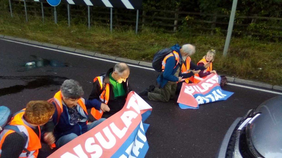 Climate protesters arrested for GLUING themselves to road despite ...